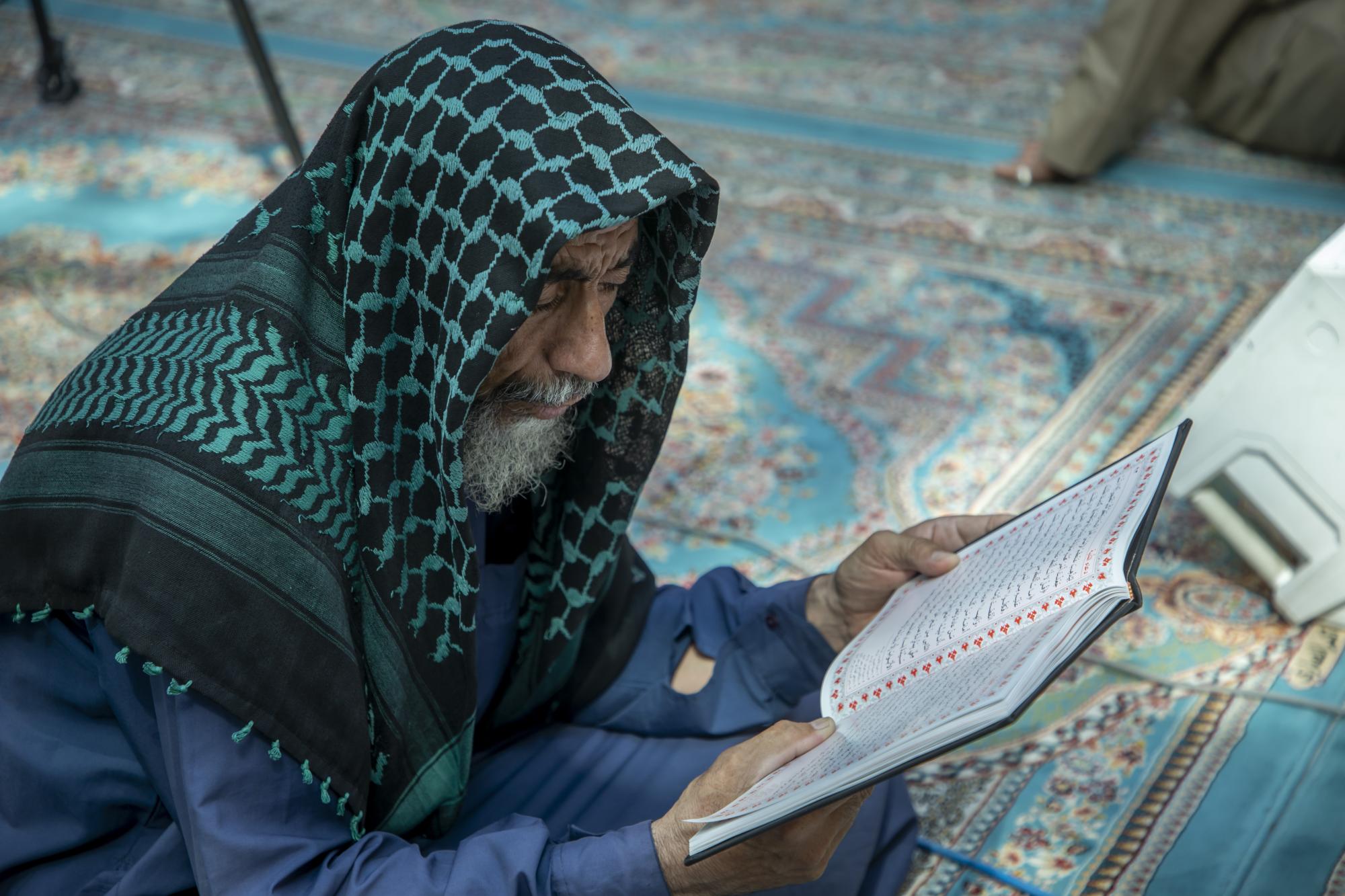 Visitors perform the rituals of reading the Dua al-Nudba in the ...